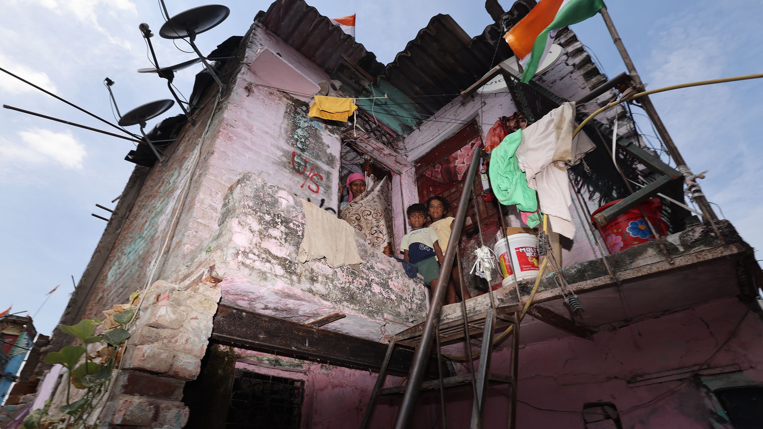 Through the Lens: India demolishes slums and youth race for government jobs